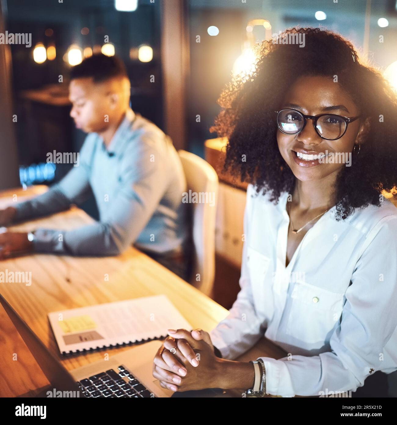 Hard work comes naturally to all in this office. Portrait of a young ...