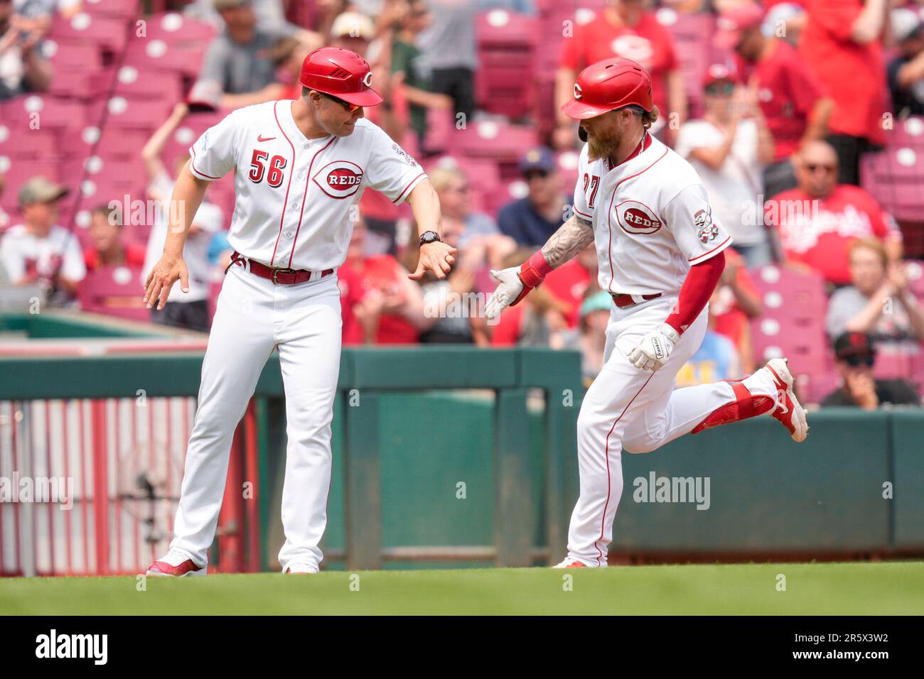 Cincinnati Reds' Jake Fraley (27) celebrates with third base coach J.R ...