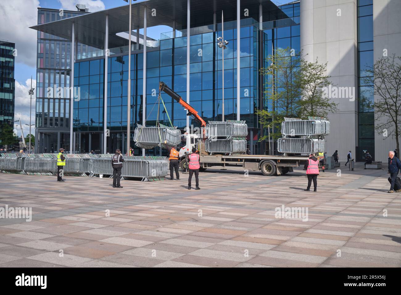 Workers installing crowd barriers outside Cardiff Central Railway ...