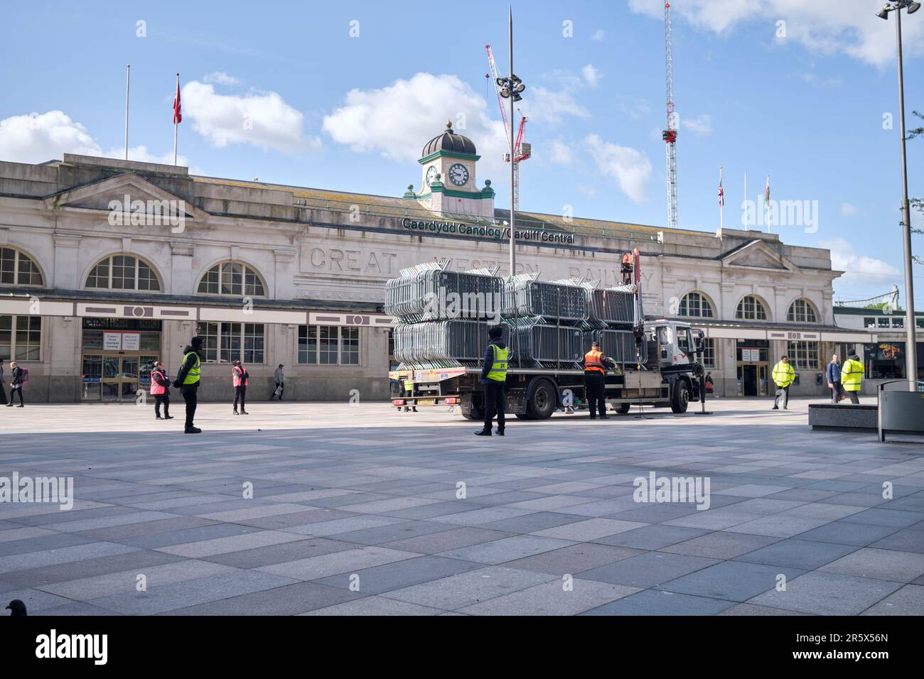 Workers installing crowd barriers outside Cardiff Central Railway ...