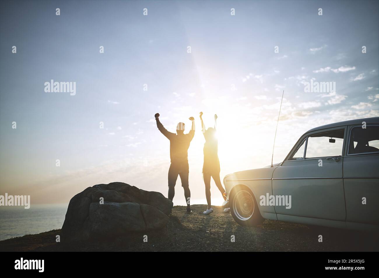 Life is pretty amazing. a young couple making a stop at the beach while ...