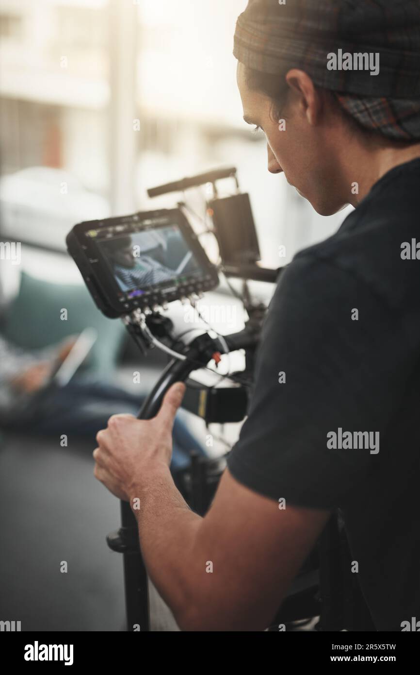 Keep rolling. Behind the scenes shot of a camera operator shooting a ...