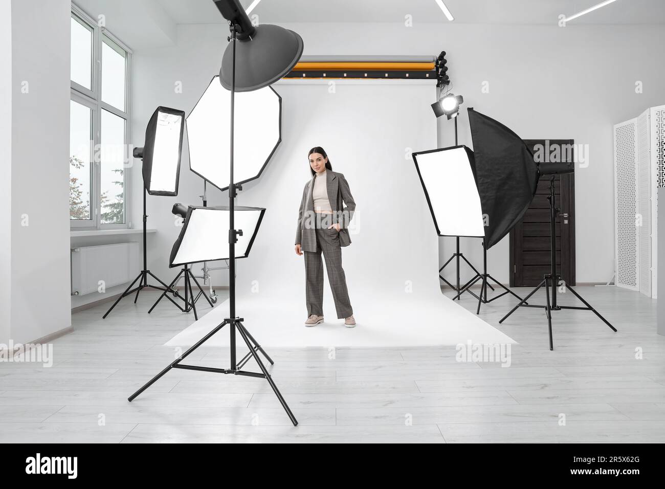 Beautiful young model posing in modern studio. Professional photo ...