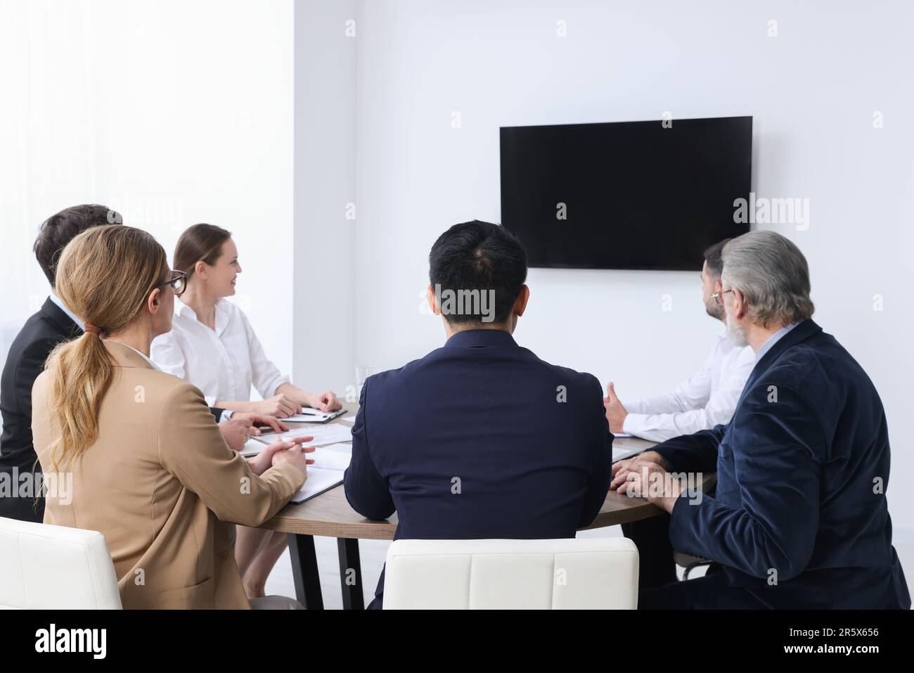 Business conference. Group of people watching presentation on tv screen ...