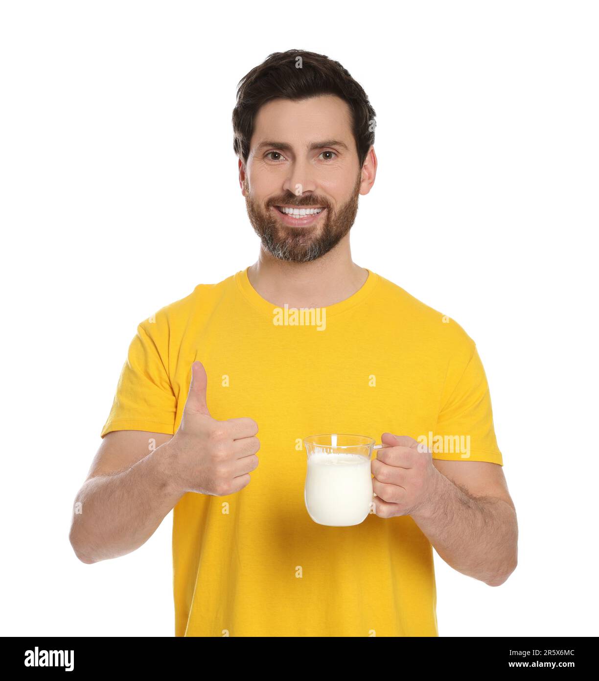 Handsome man with delicious yogurt showing thumb up on white background ...