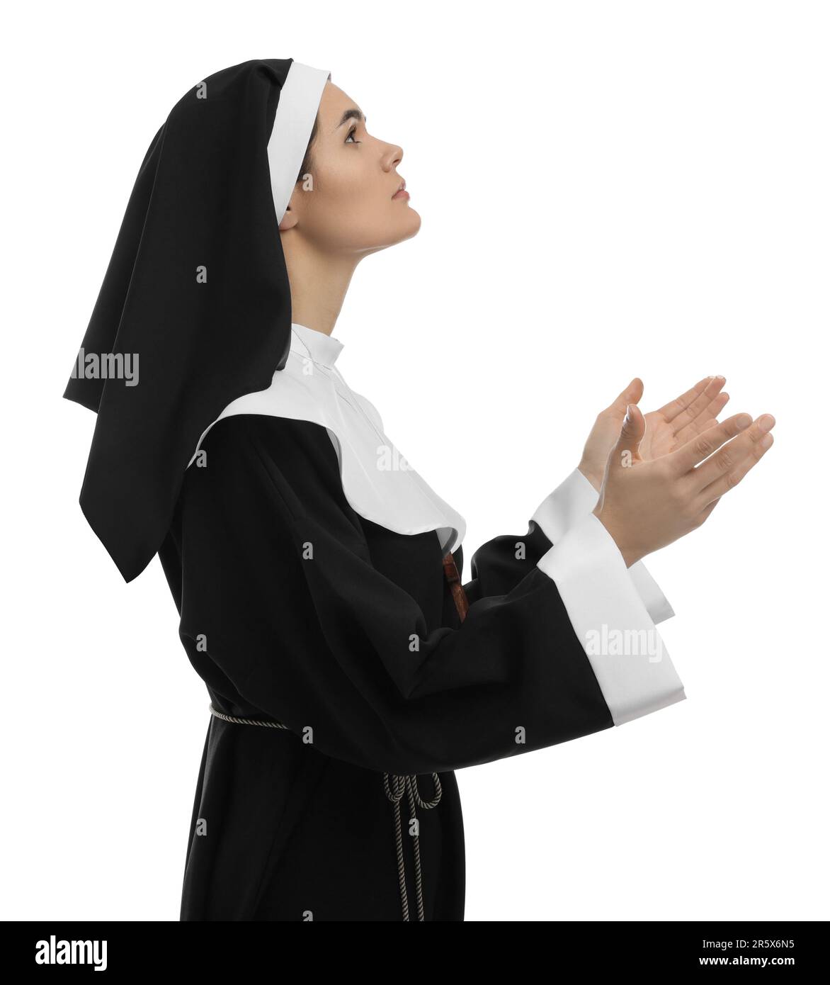 Nun praying to God on white background Stock Photo - Alamy