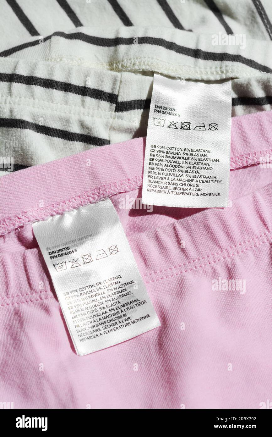 Clothing labels with instructions on garments, top view Stock Photo - Alamy