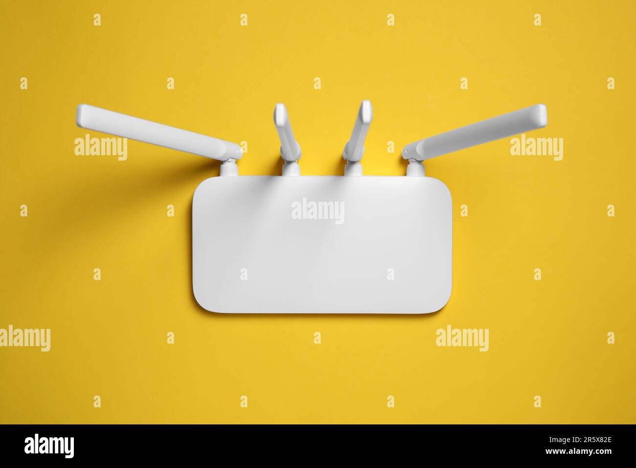 New white Wi-Fi router on yellow background, top view Stock Photo - Alamy