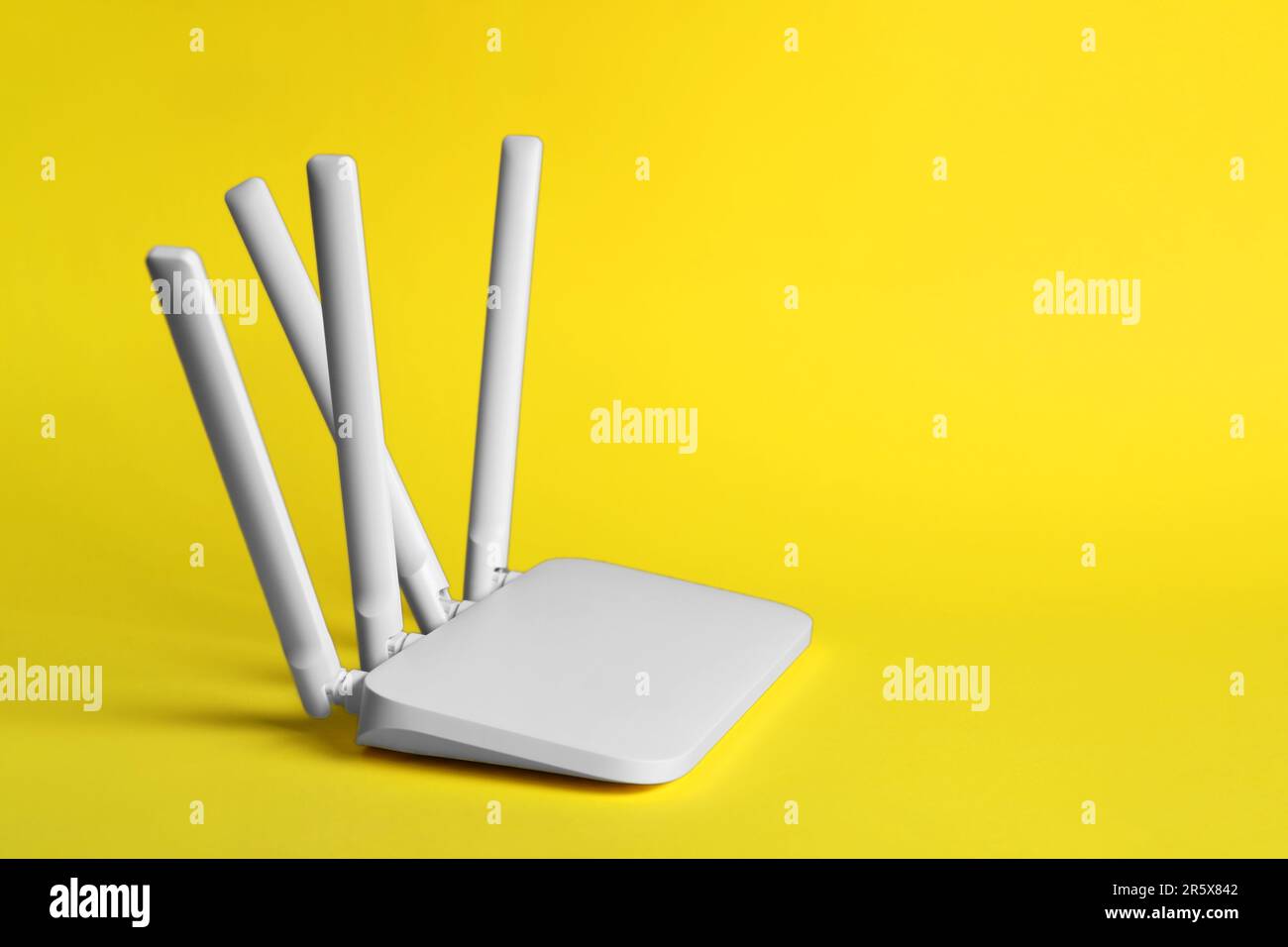 New white Wi-Fi router on yellow background, space for text Stock Photo ...