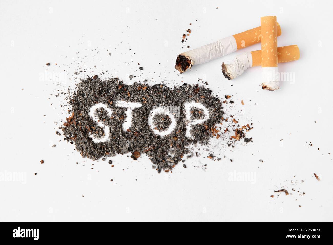 Word Stop made of cigarette ash and stubs on white background, flat lay ...