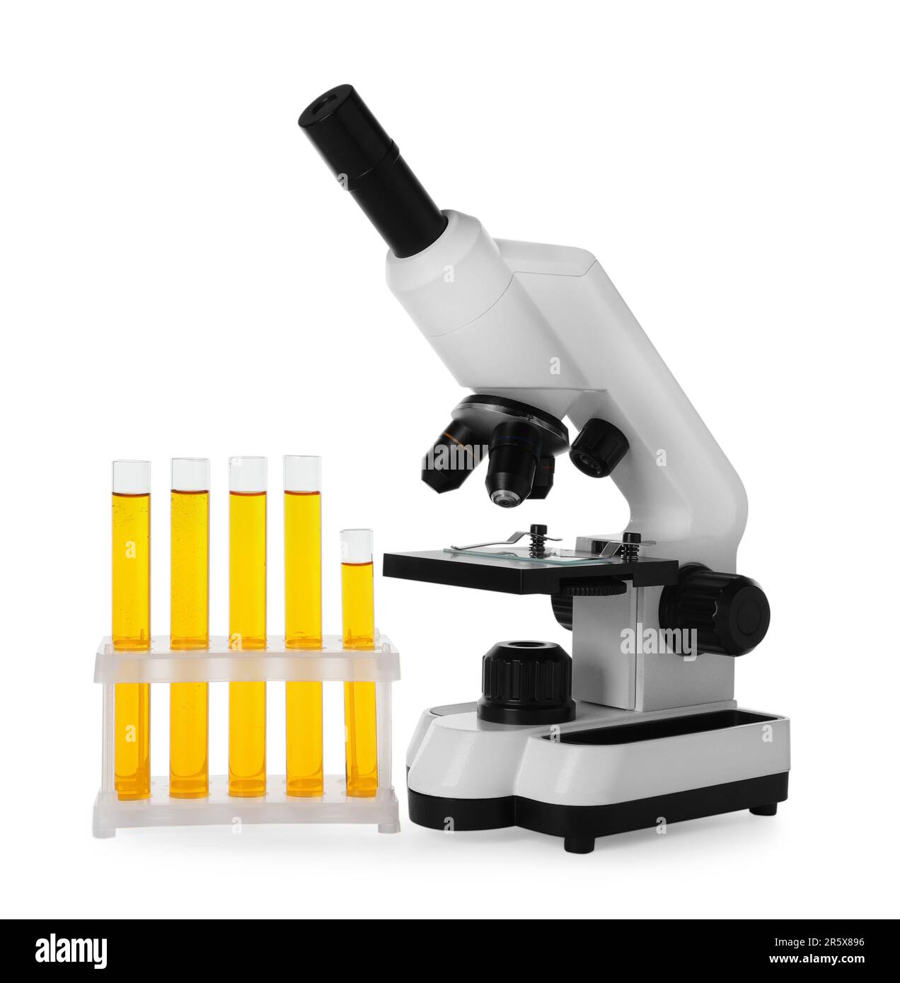 Test tubes with orange liquid and microscope isolated on white Stock ...