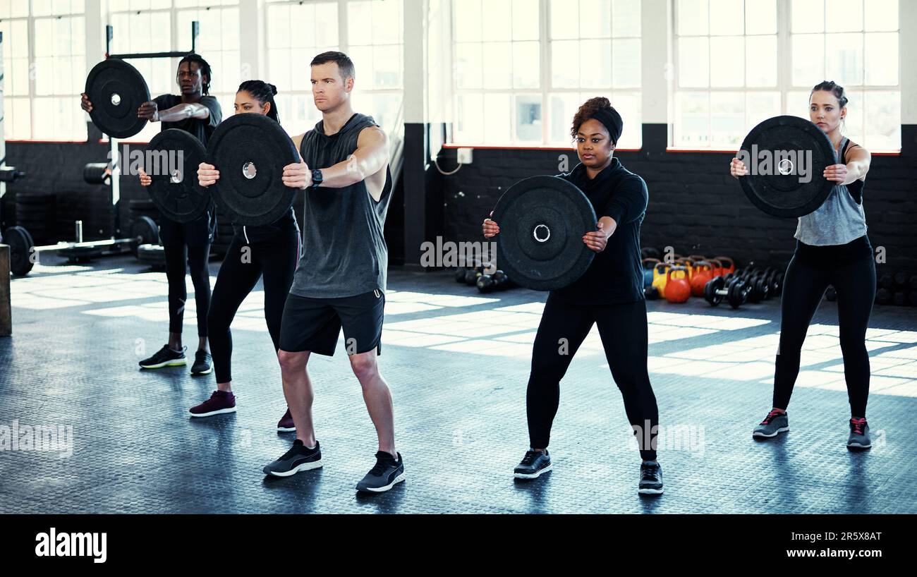 We all strive to live healthier. a fitness group using kettle-bells in ...