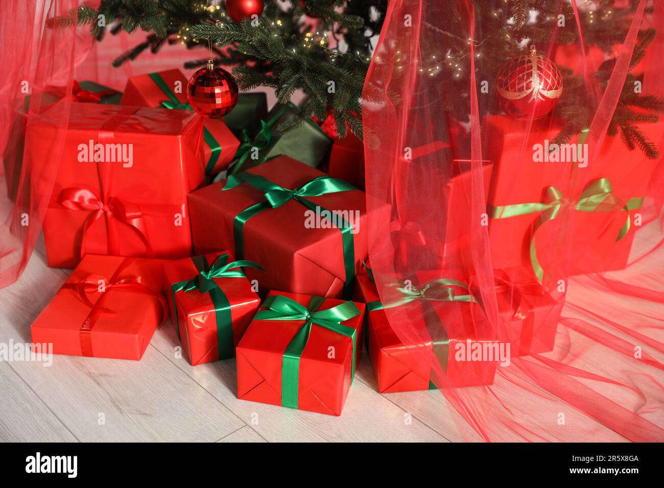 Beautifully wrapped gift boxes under Christmas tree indoors Stock Photo ...
