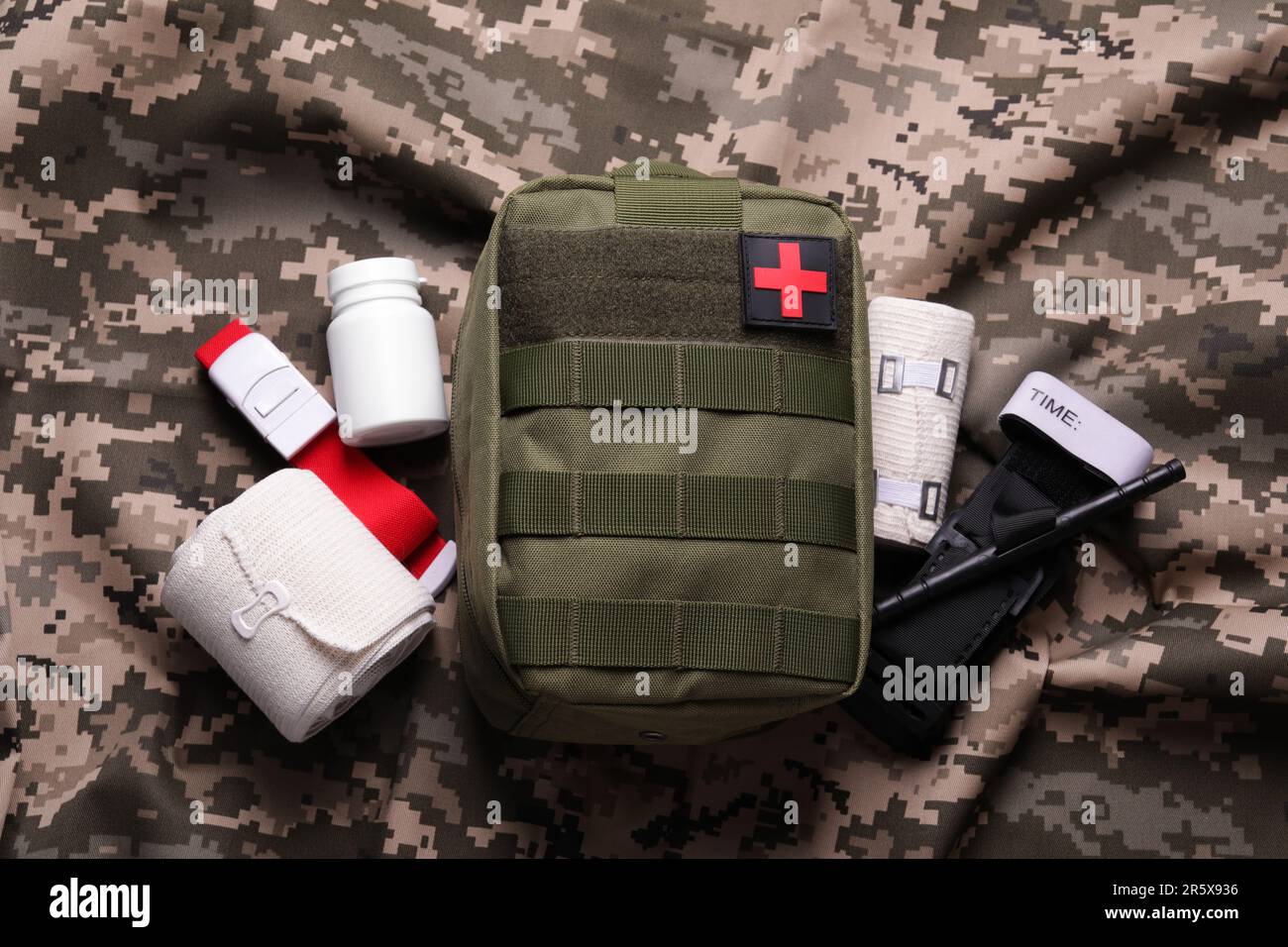 First aid kit with medical tourniquet, pills and bands on military ...
