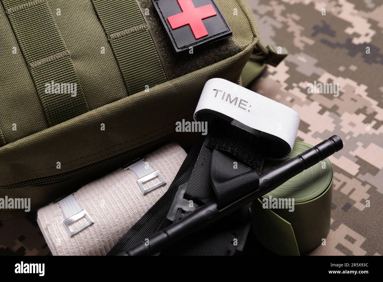 First aid kit with medical tourniquet and elastic bands on military ...