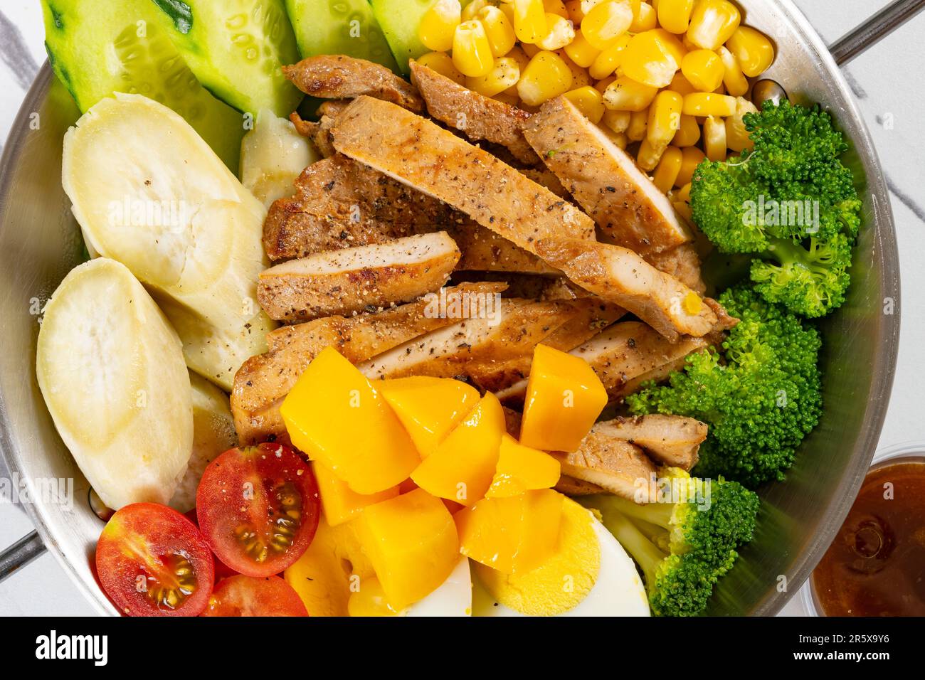 top view healthy meal with chicken and cucumber and eggs and broccoli ...