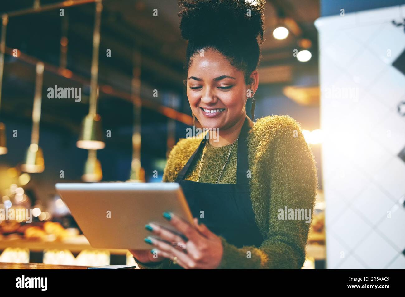 The smartest tool to support cafe operations. a young woman using a ...