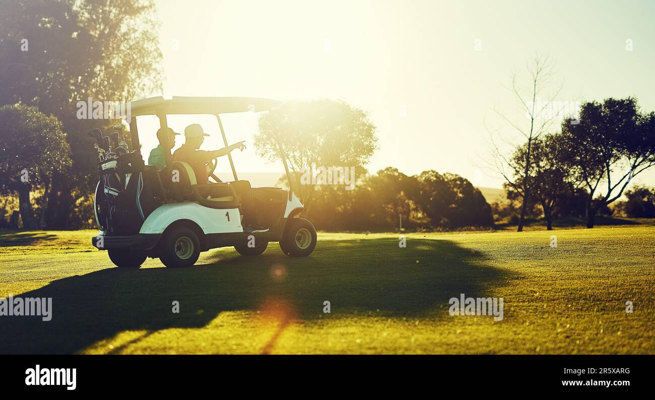 Gone golfing. two golfers riding in a cart on a golf course Stock Photo ...