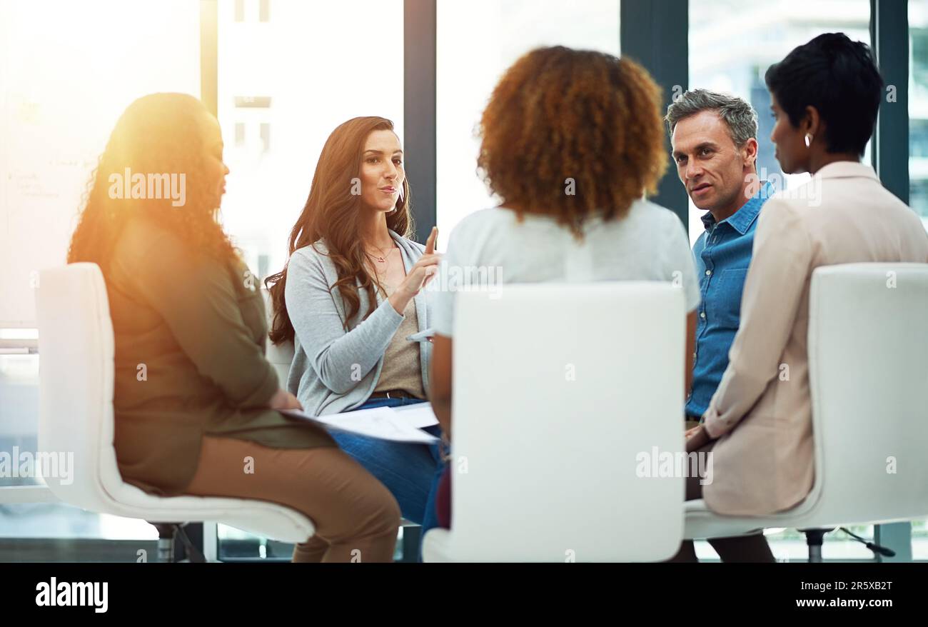 No update goes unshared. a team of colleagues having a meeting in a ...