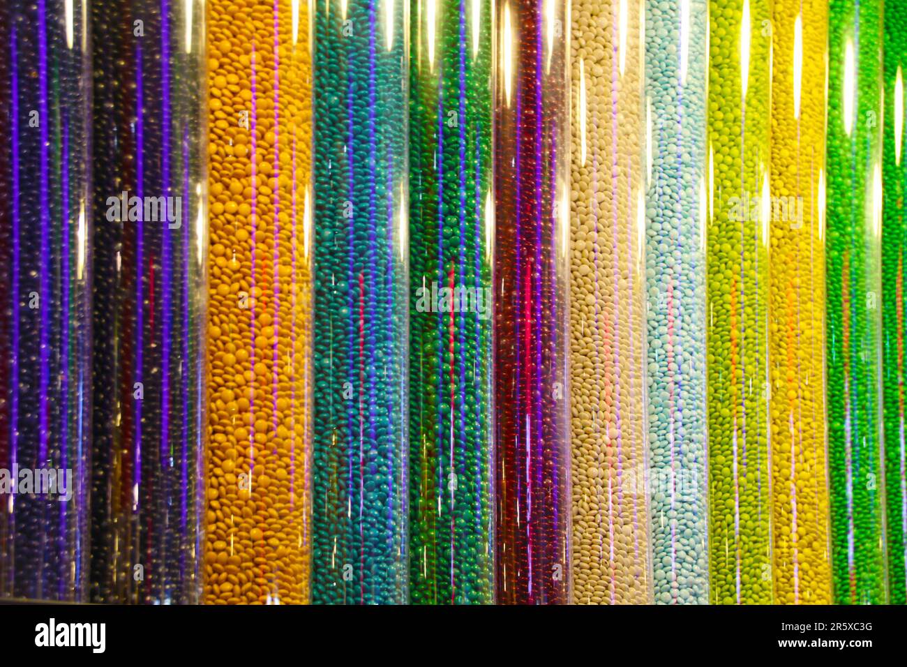 Colorful candies inside shiny cylindrical containers Stock Photo - Alamy