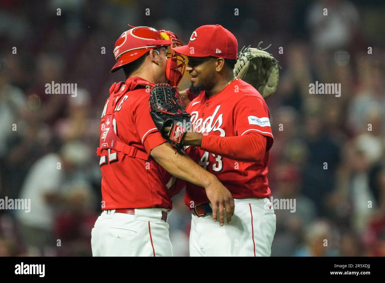 Cincinnati Reds' Luke Maile, left, hugs Alexis Diaz after the final out ...