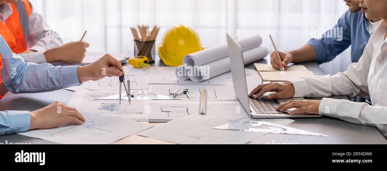 Architect or engineer working on building blueprint, contractor ...