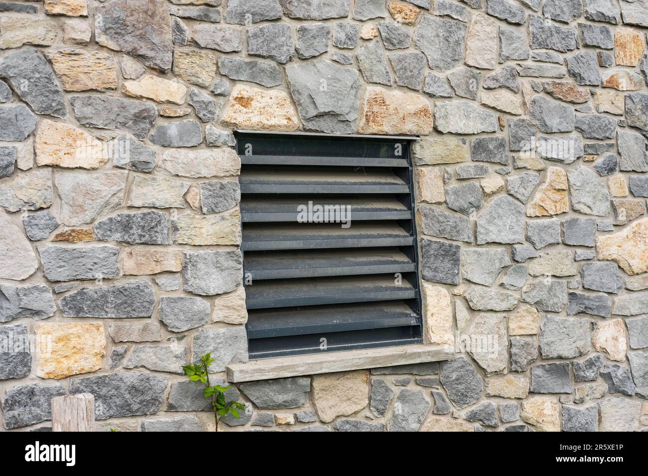 Window of a house closed with black wooden shutters. Old, ancient wood ...