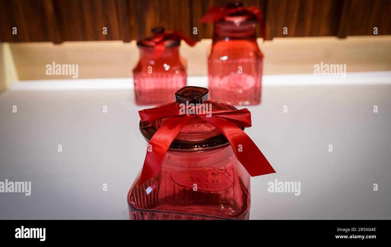 A Red Ribbon Adorned Jar is a beautifully crafted jar that has been ...