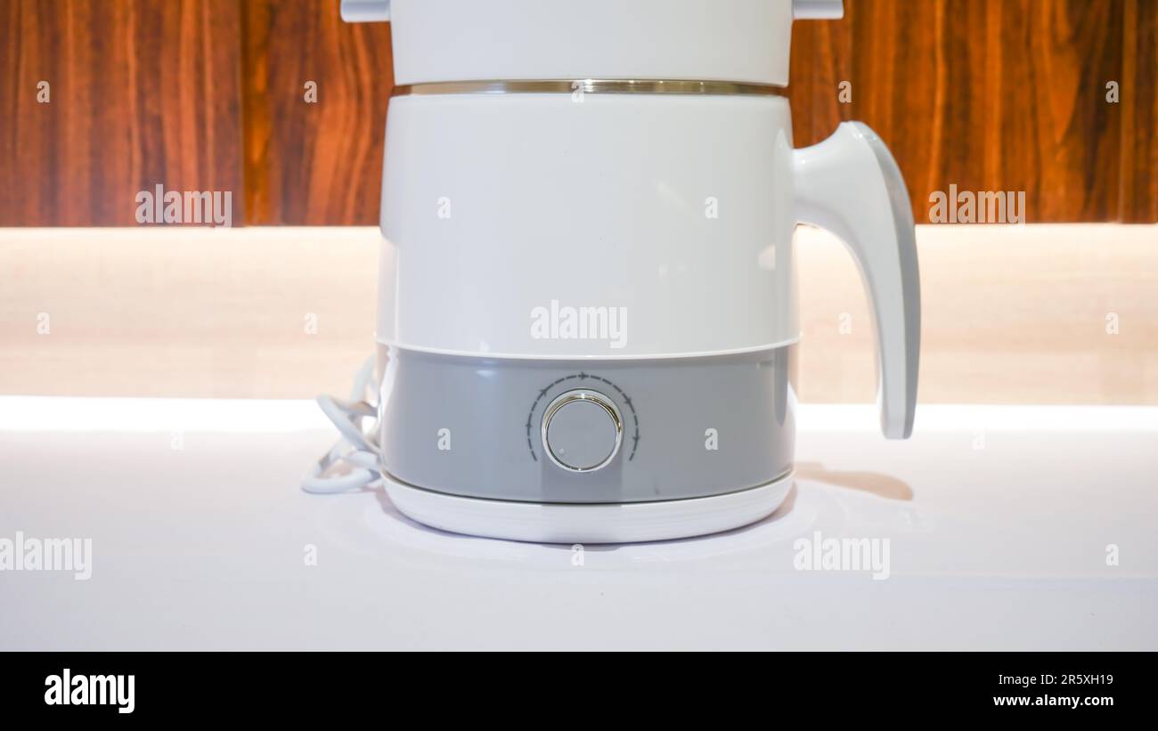 A white electric steamer is a kitchen appliance used for steaming food ...