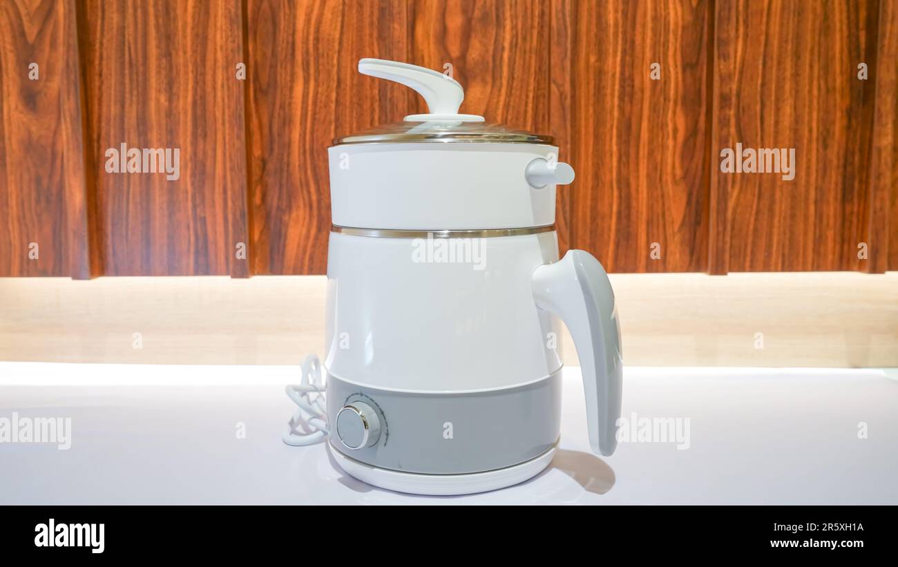 A white electric steamer is a kitchen appliance used for steaming food ...