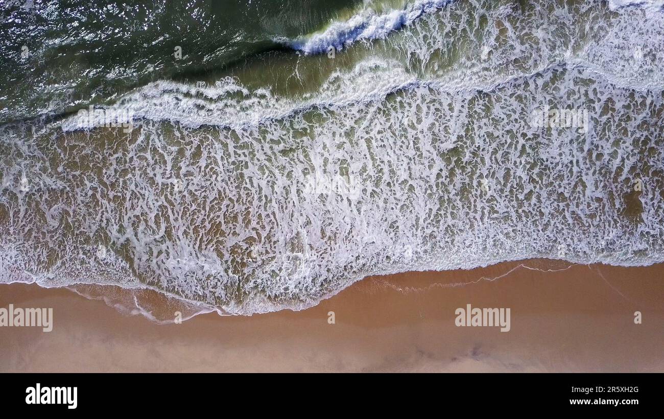 Aerial view of ocean waves crashing on beach, 4K drone footage Stock ...