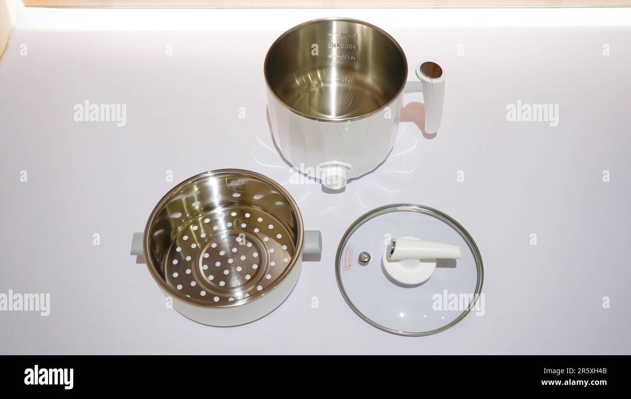 A white electric steamer is a kitchen appliance used for steaming food ...