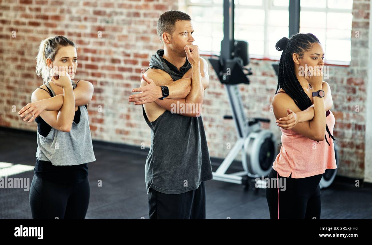 Keep those muscles loose. a focused group of young people standing in a ...