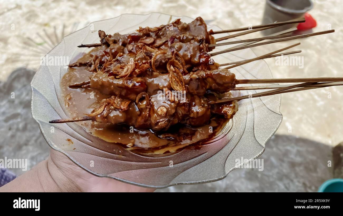 Grilled chicken satay with peanut sauce and crispy fried onion toppings ...