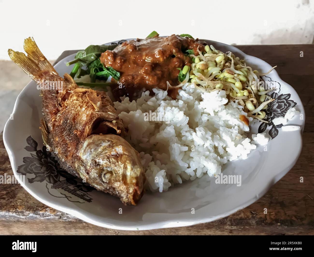 Crispy fried fish with bean sprouts, vegetables, and peanut sauce rice ...