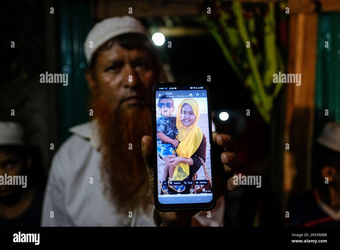 Rohingya refugee Muhammad Ayub shows a photo of his daughter, Samira ...