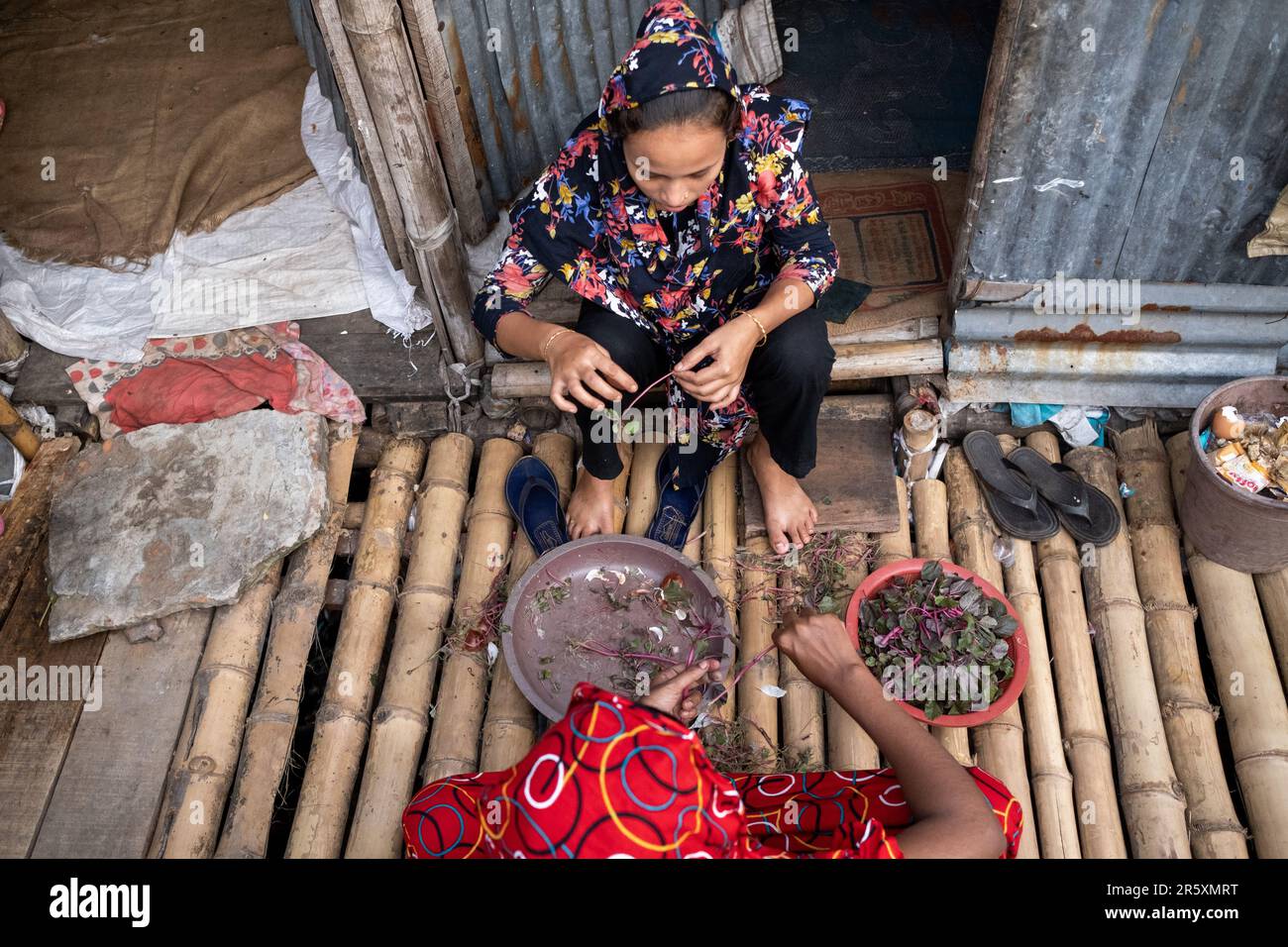People cooking. The slum of Duari Para in Dhaka, the capital of ...