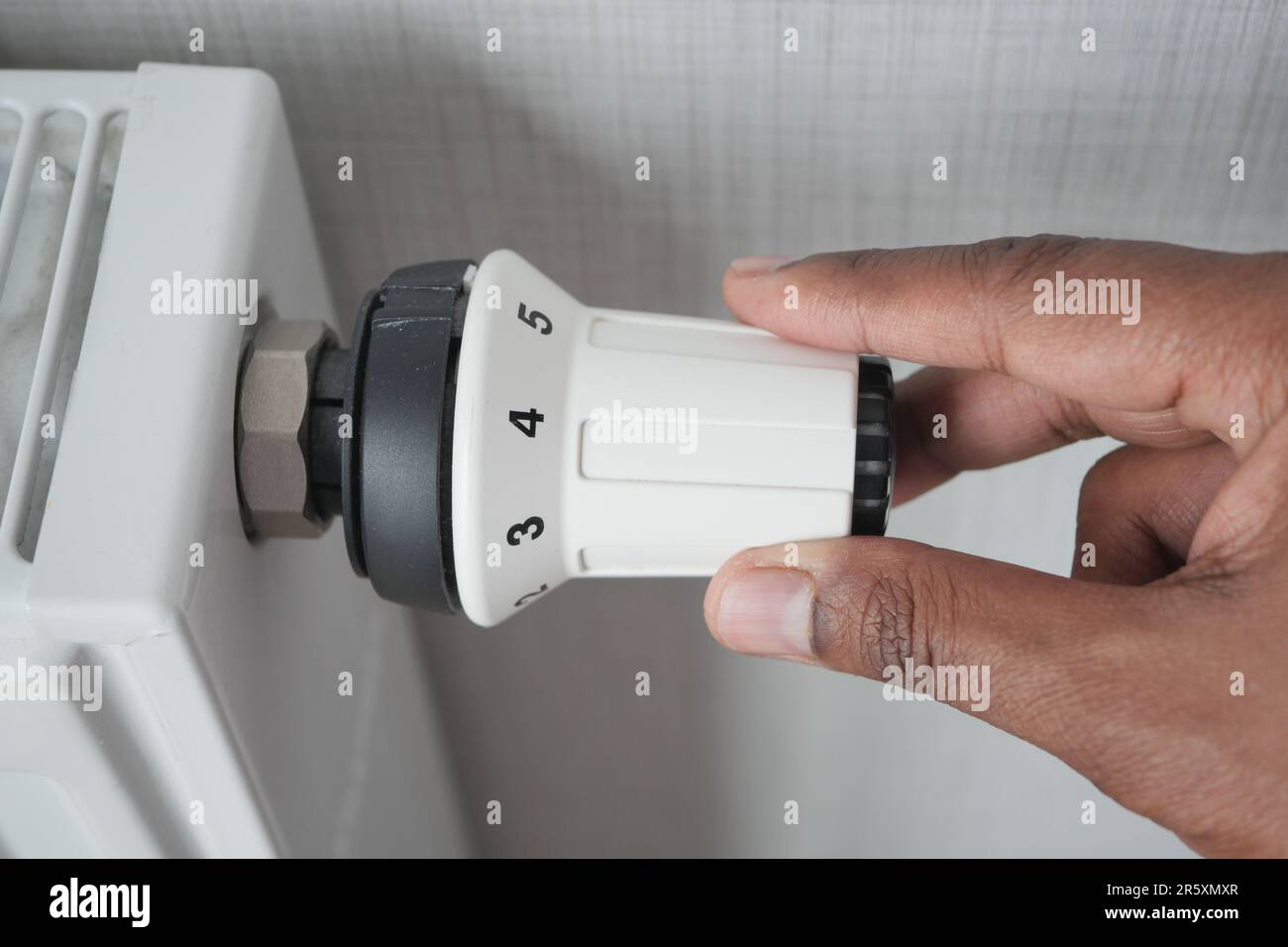 adjusting temperature on heating radiator Stock Photo - Alamy