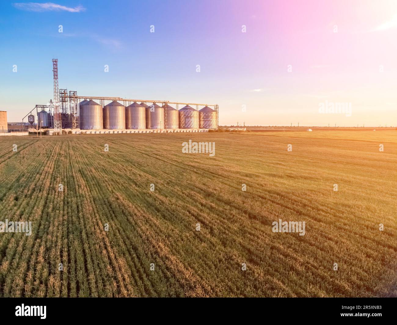 Modern metal silos on agro-processing and manufacturing plant. Aerial ...