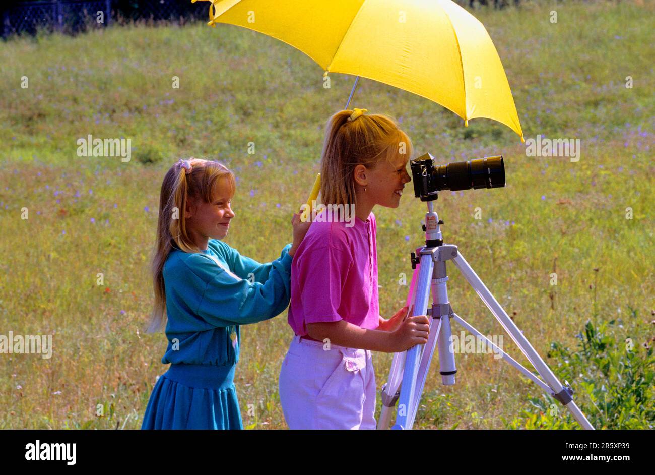 Child up to 6 years, 2 girls playing with camera with tripod Stock ...