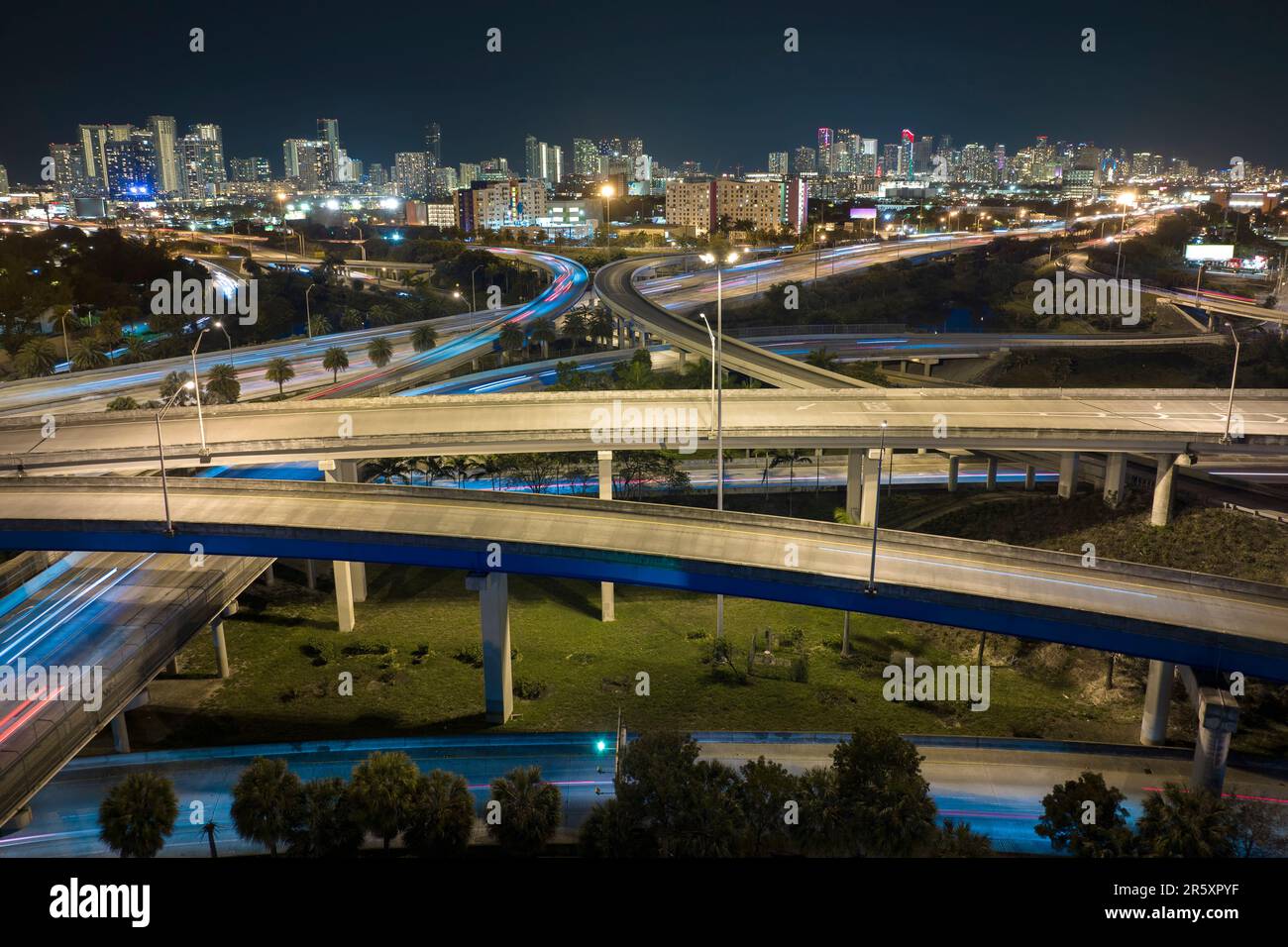 Aerial view of american freeway intersection at night with fast driving ...