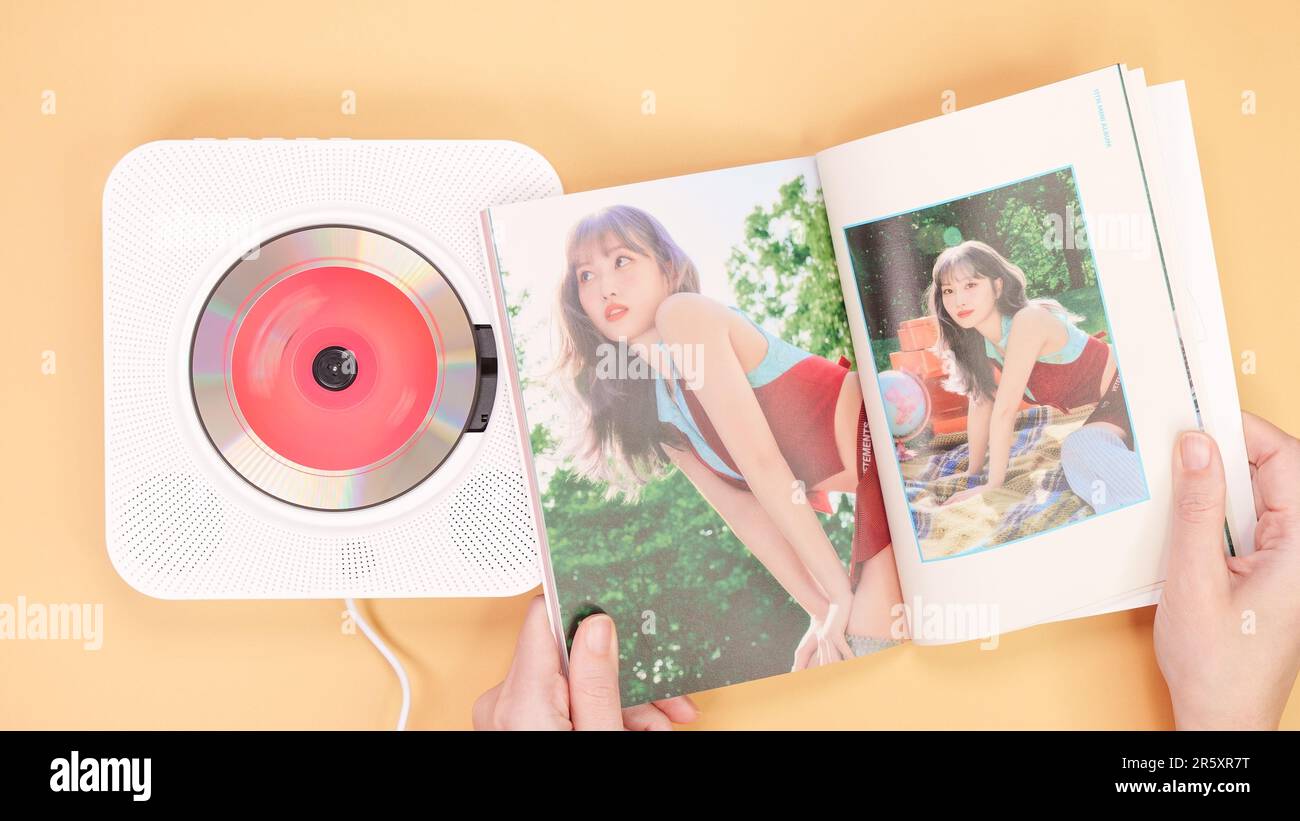Hands holding Twice Between 1 and 2 mini Album photobook on yellow ...