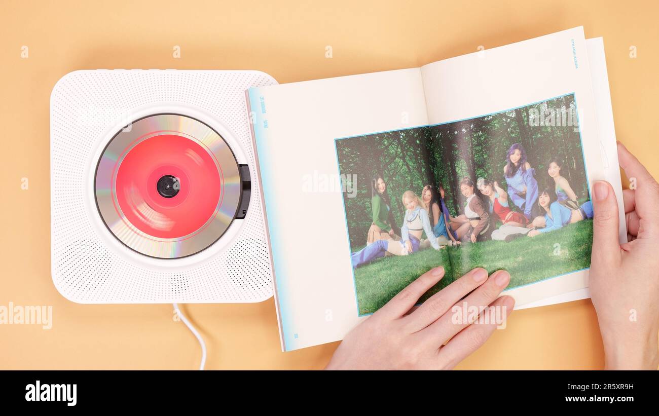 Hands holding Twice Between 1 and 2 mini Album photobook on yellow ...
