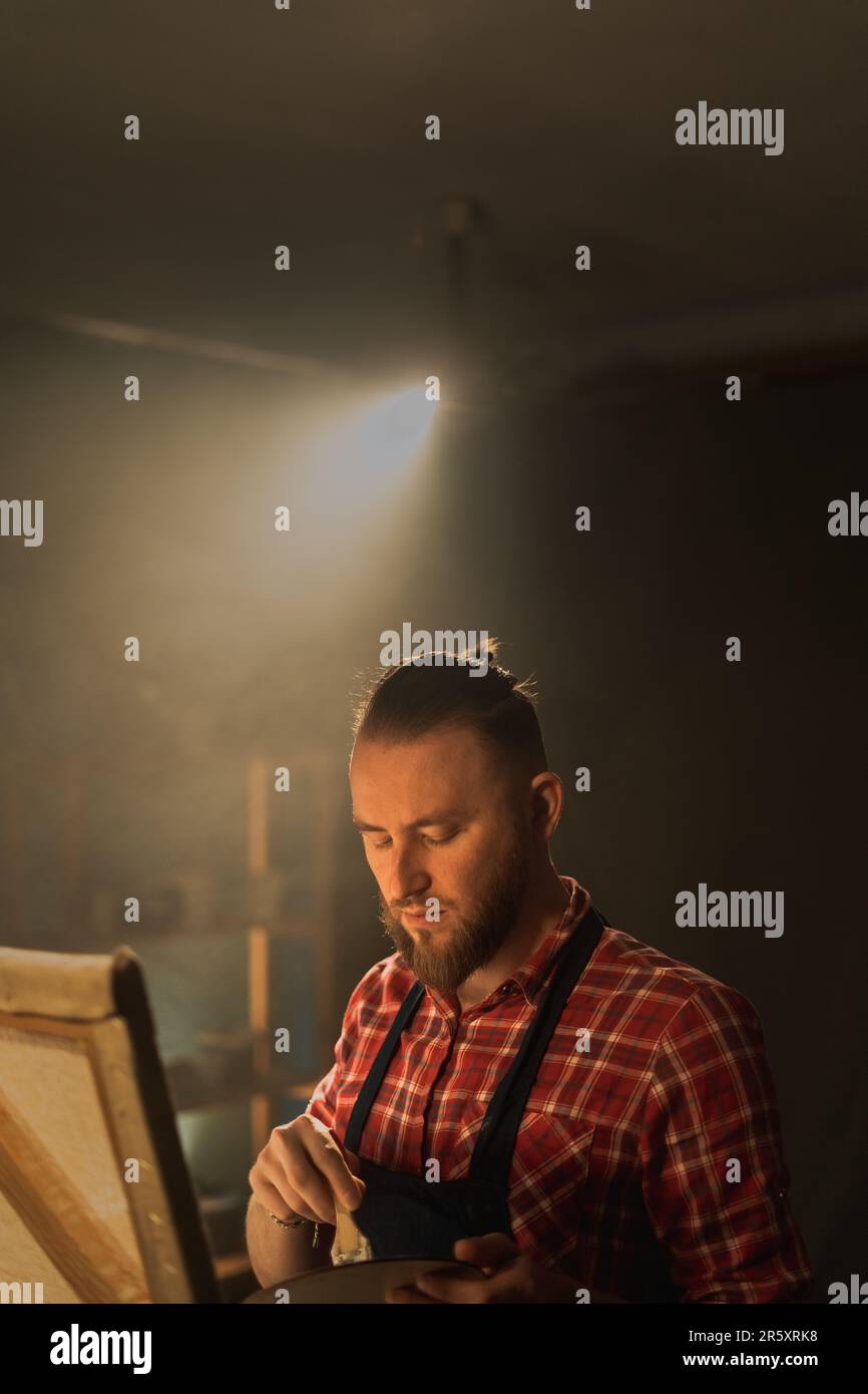 Talented handsome artist working on abstract painting, drawing modern ...