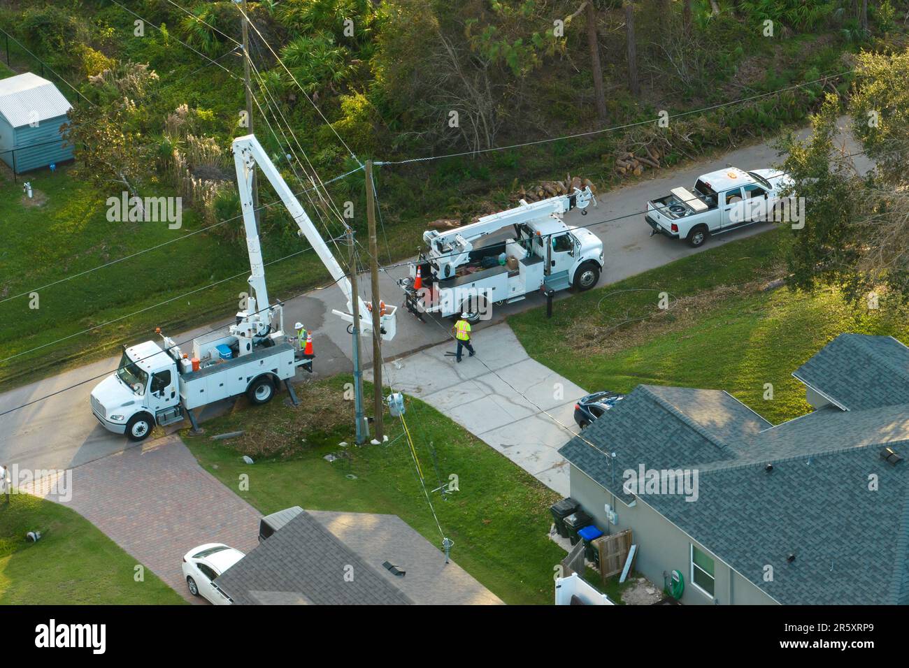 Aerial view of electrician workers repairing damaged power lines after ...