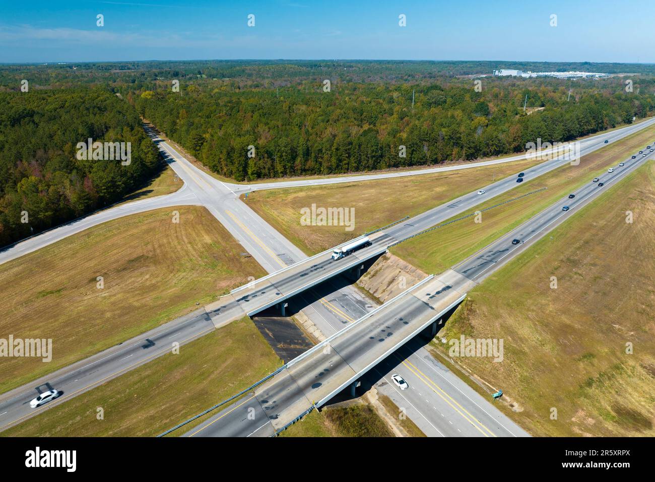 Aerial view of freeway overpass junction with fast moving traffic cars ...