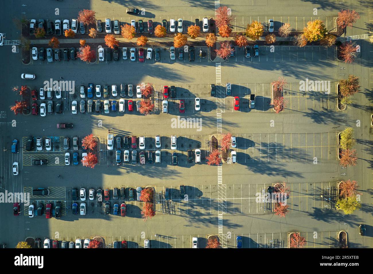 Aerial view of many colorful cars parked on parking lot with lines and ...
