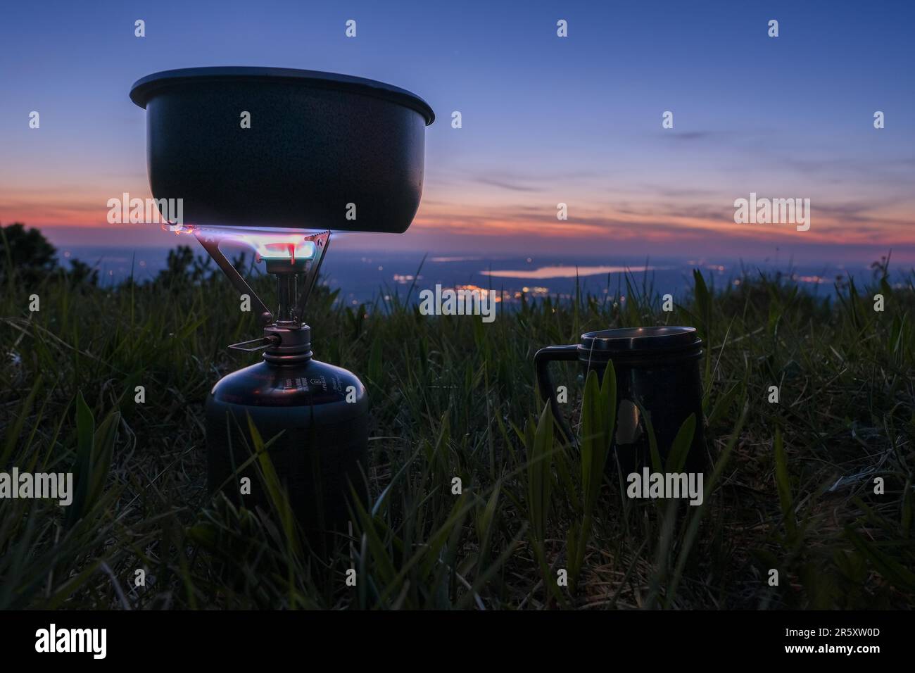 Gas cooker boiling water while camping in the mountains, sleeping on a ...