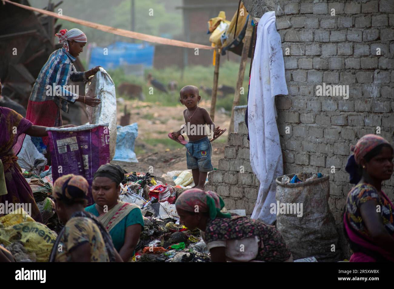 GUWAHATI, INDIA, JUNE 4: A child standing next to ragpickers at the ...