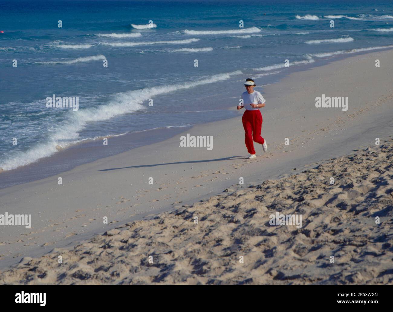 Jogging on the beach Stock Photo - Alamy
